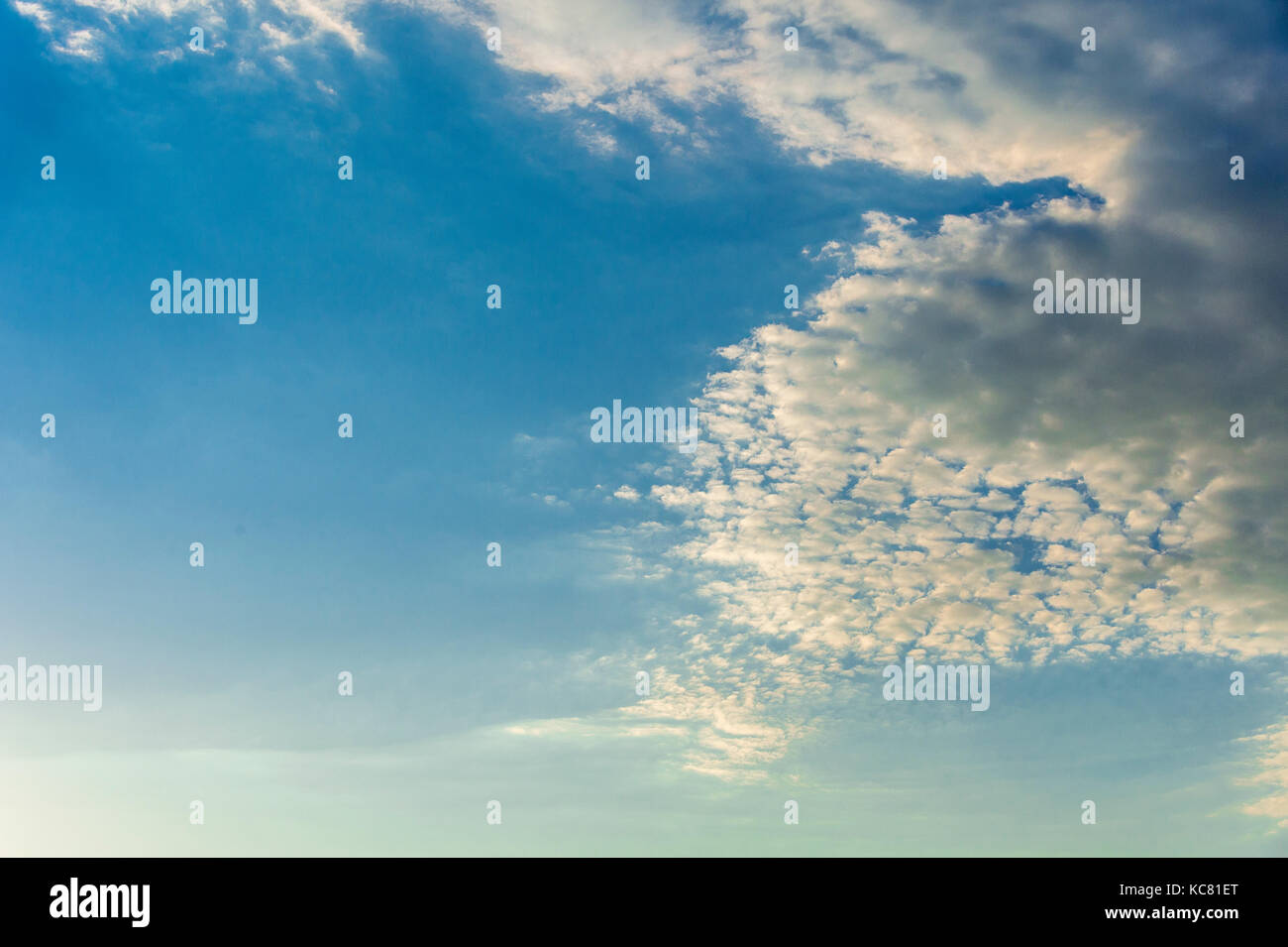 Blue sky with scattered clouds at the beginning of sunset Stock Photo ...