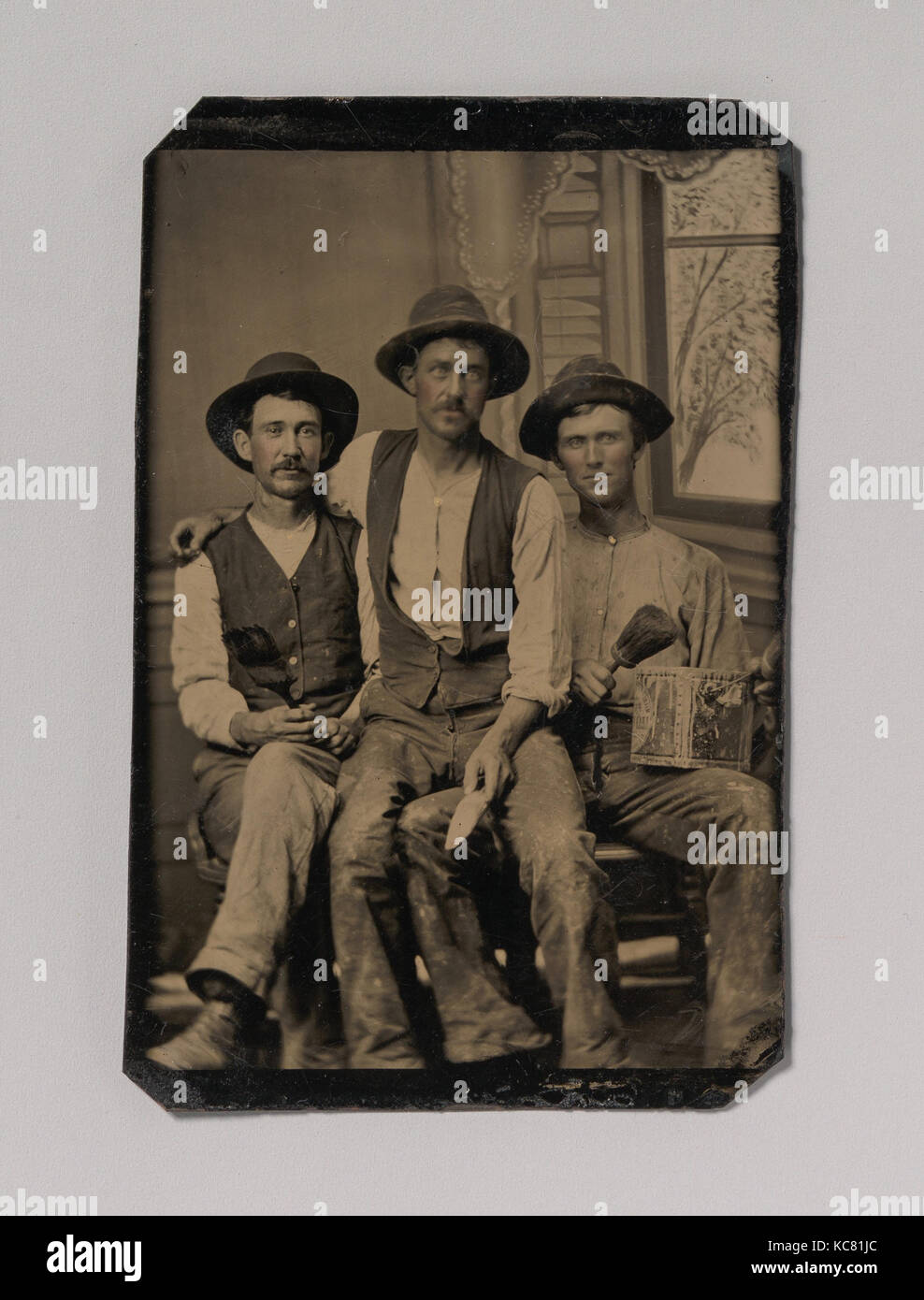 Three Painters, with Brushes and a Can of Paint, in Front of a Painted ...