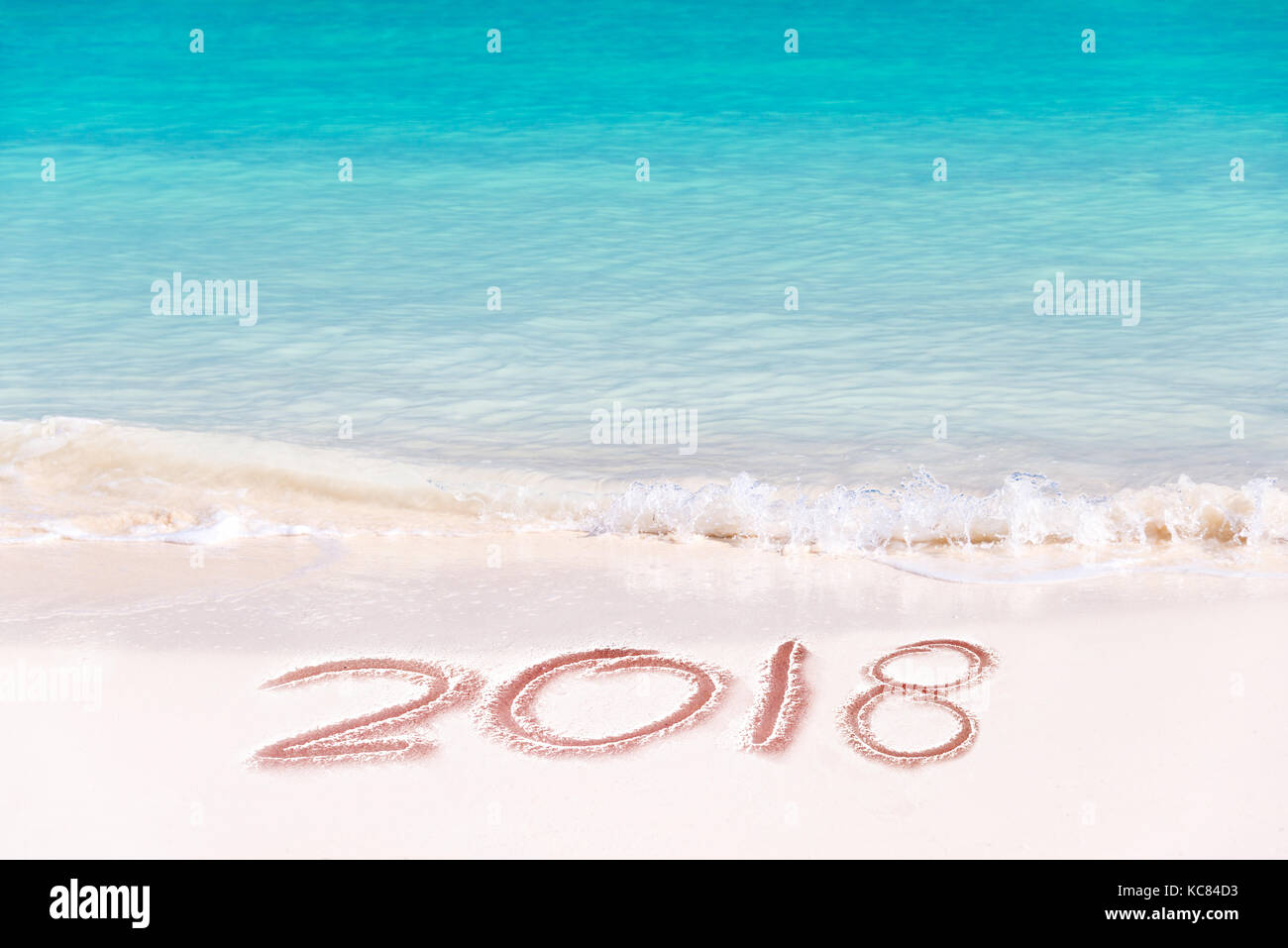 2018 written on the sand of a beach, travel 2018 new year concept Stock ...