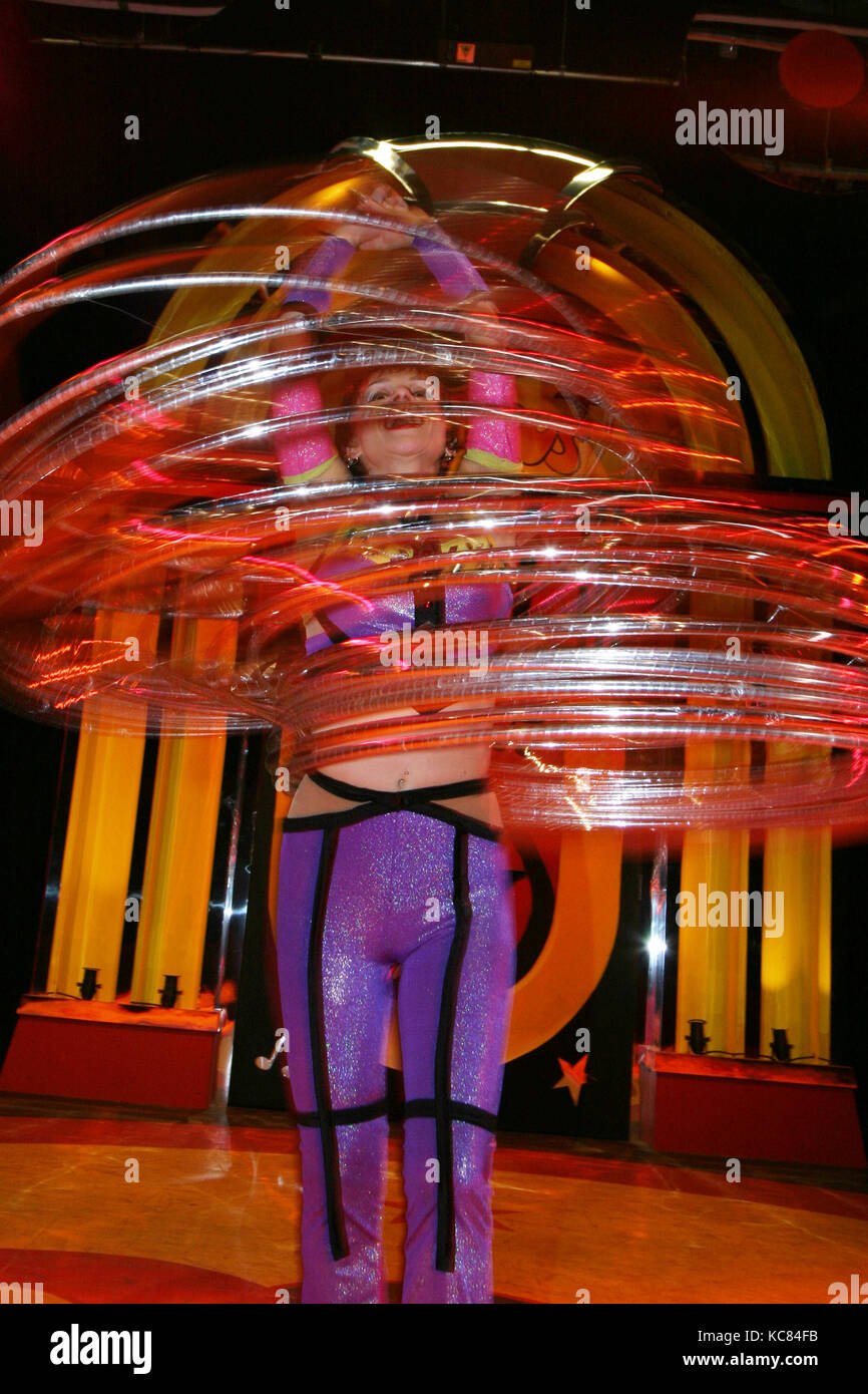 Woman performing a hula hoop act in a circus Stock Photo - Alamy
