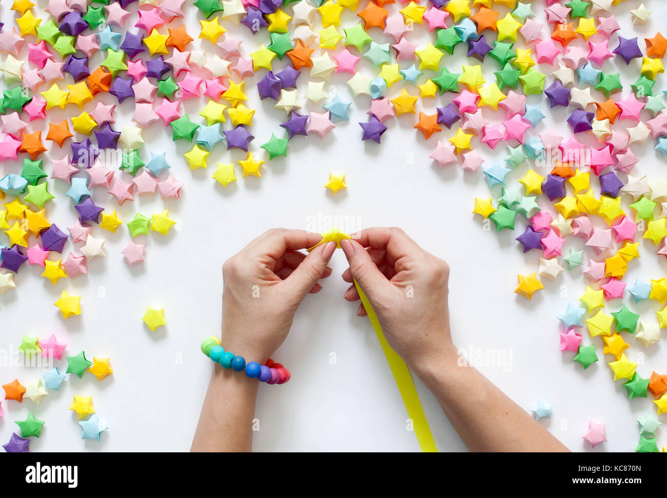 Hands holding origami stars Stock Photo - Alamy