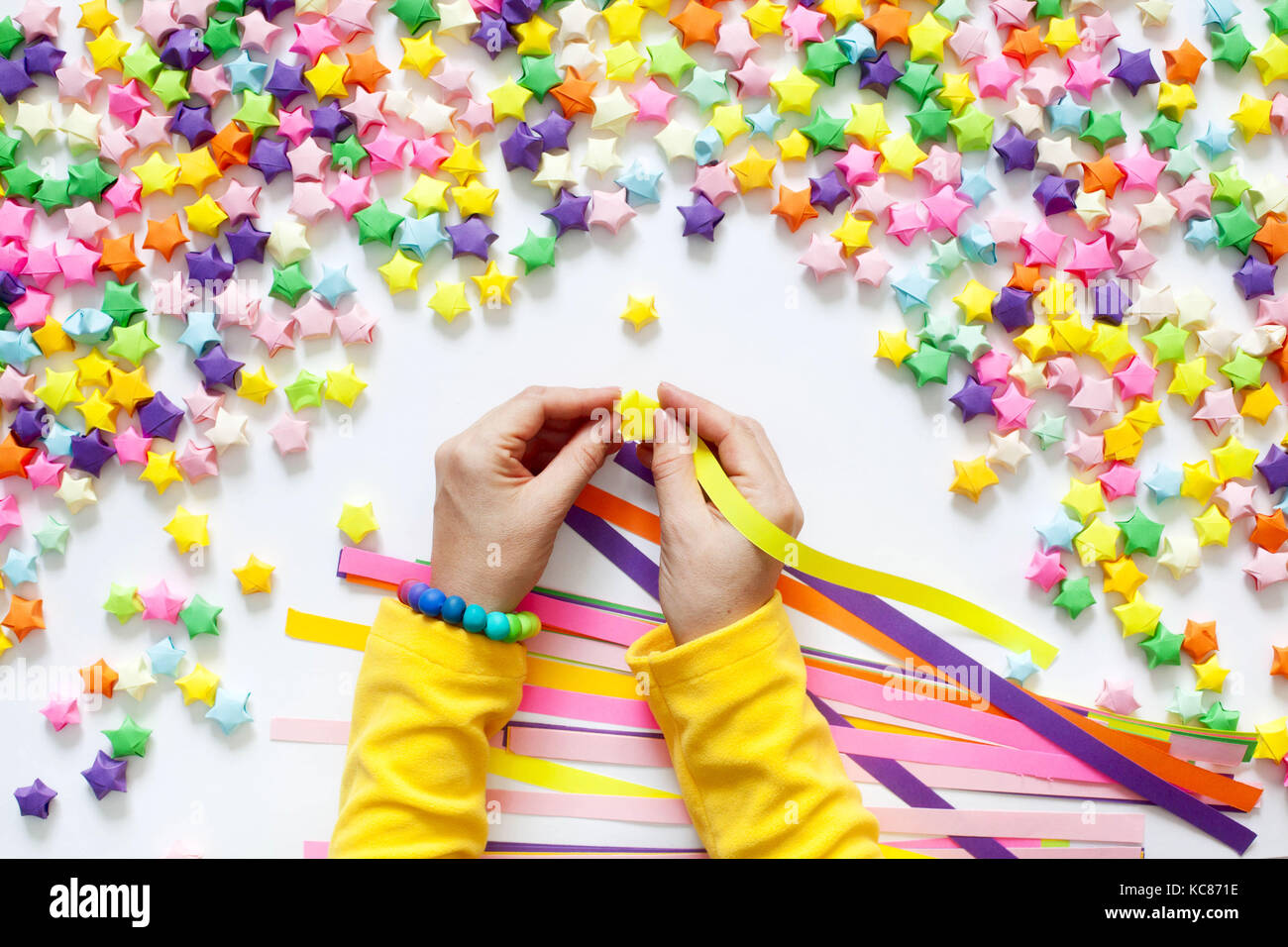 Hands holding origami stars Stock Photo - Alamy