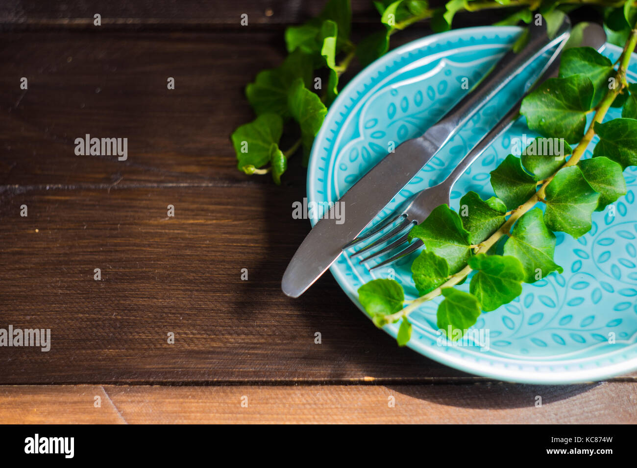 Rustic table setting with vintage ceramic plates and branch of ivy ...