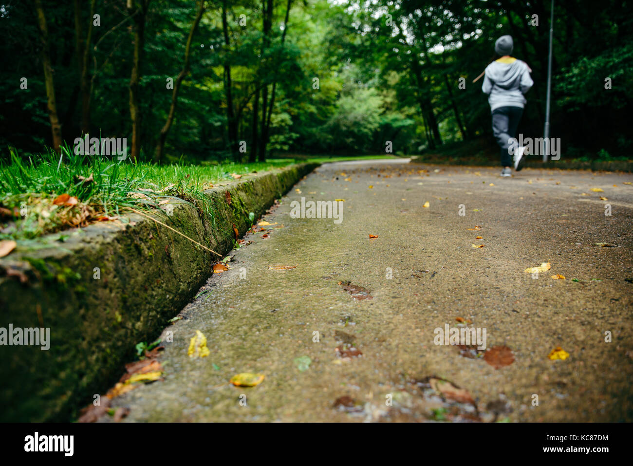 man runnin in autumn park with music in rainy weather Stock Photo - Alamy