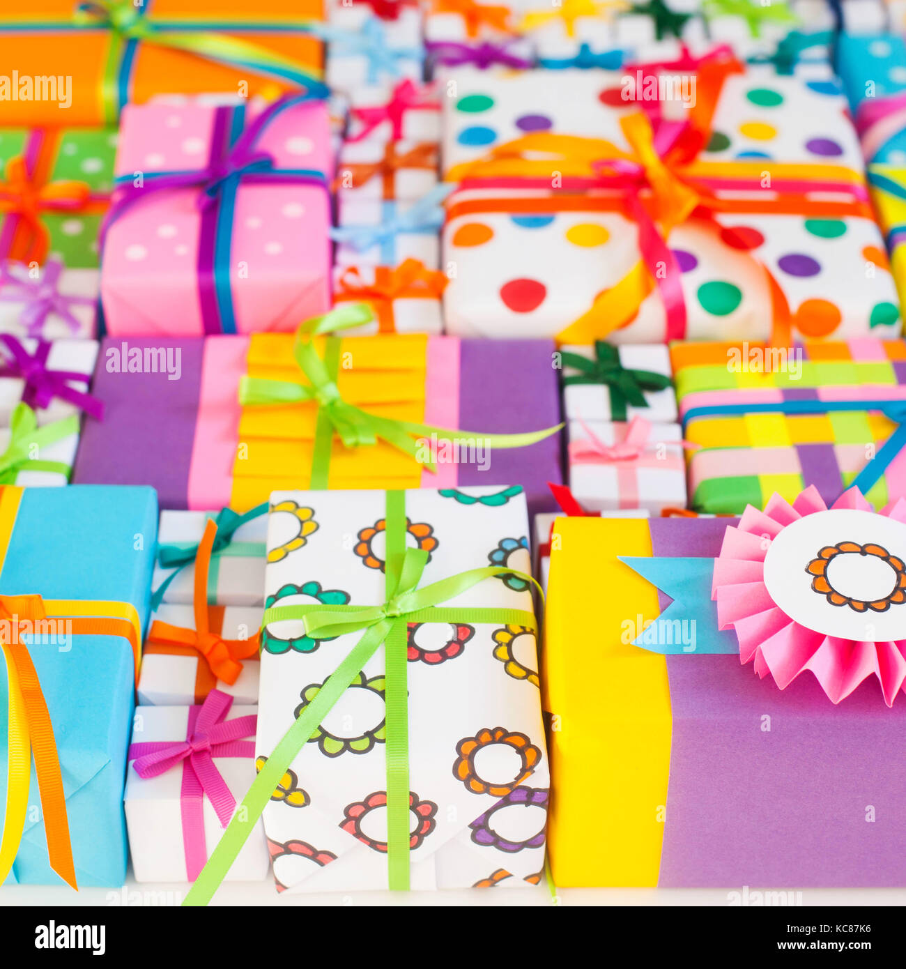Colored gift boxes with colorful ribbons. White background. Gifts for ...
