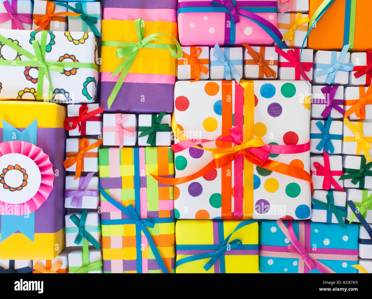 Colored gift boxes with colorful ribbons. White background. Gifts for ...