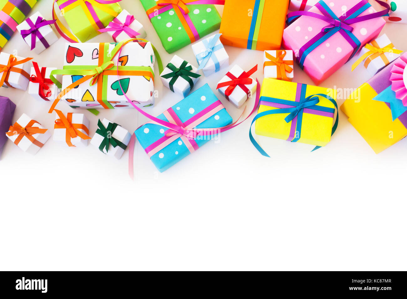 Colored gift boxes with colorful ribbons. White background. Gifts for ...