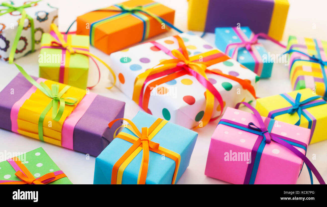Colored gift boxes with colorful ribbons. White background. Gifts for ...