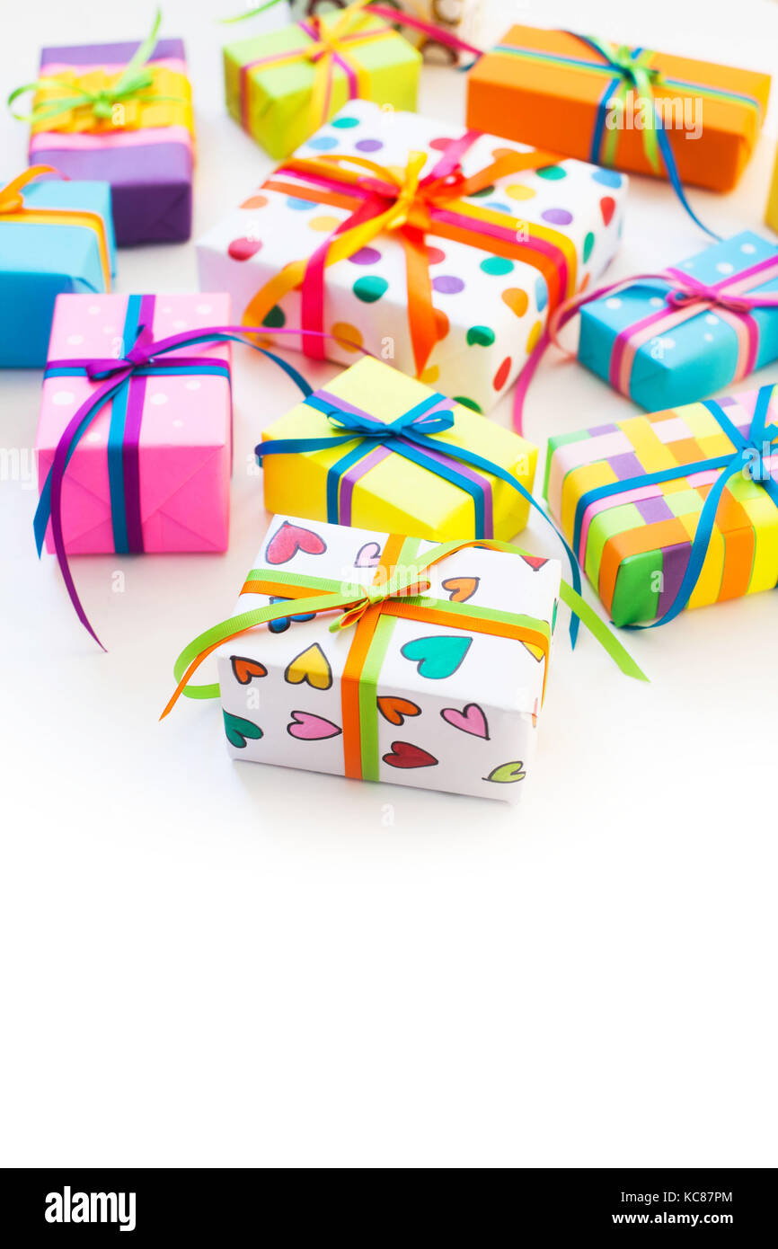 Colored gift boxes with colorful ribbons. White background. Gifts for ...