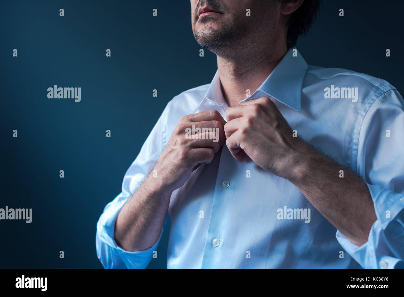 Businessman getting dressed for job interview, man buttoning white ...