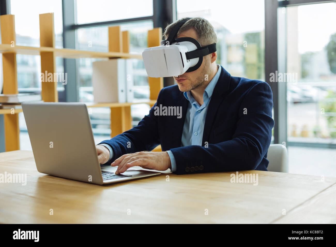 Smart professional businessman using a laptop Stock Photo - Alamy