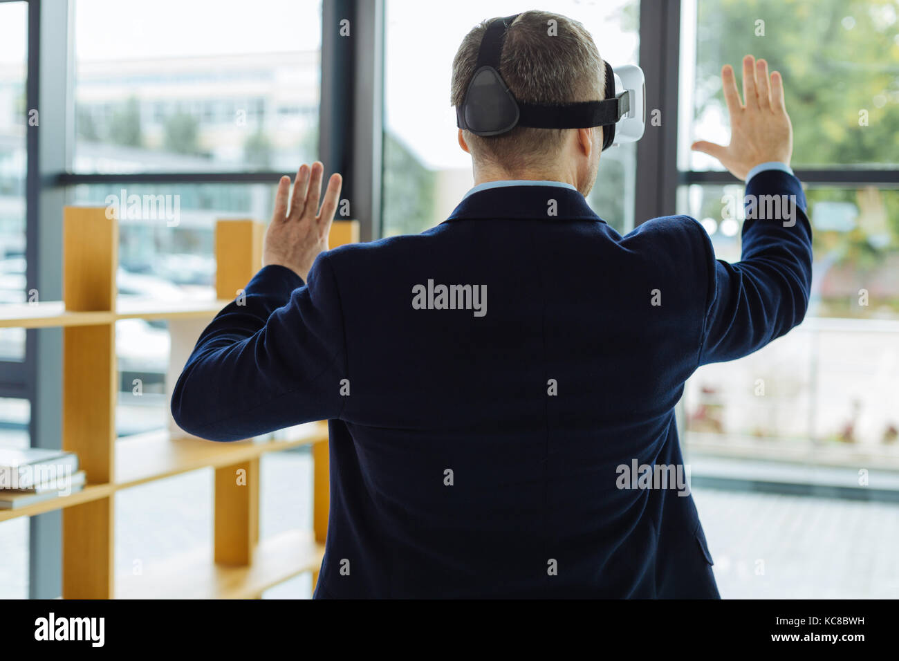 Handsome confident man looking at the window Stock Photo - Alamy