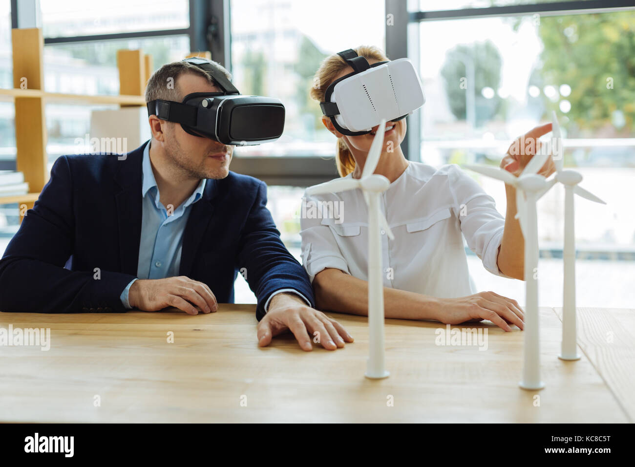 Positive friendly colleagues working in team Stock Photo - Alamy