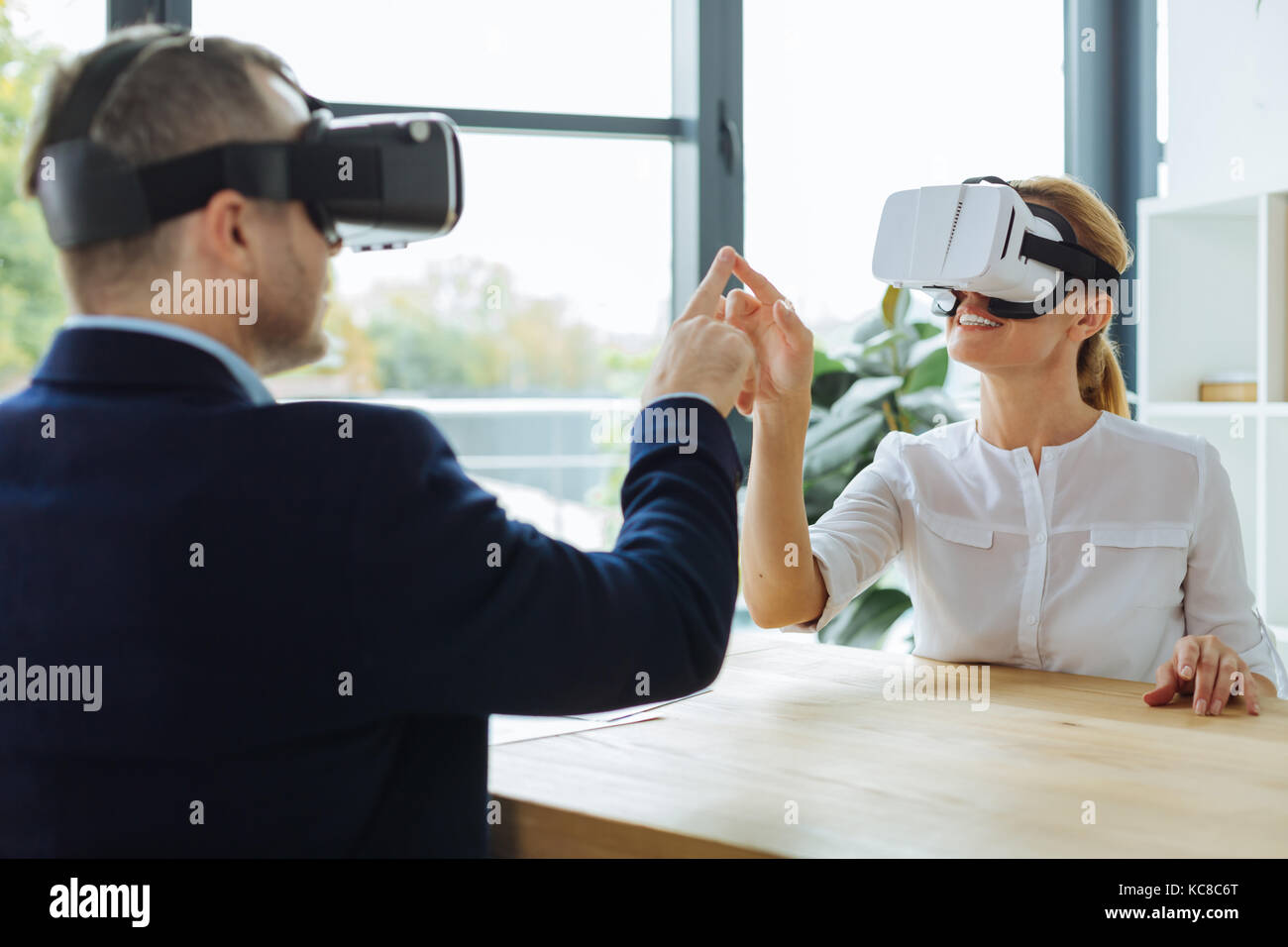 Joyful happy colleagues touching each others fingers Stock Photo - Alamy