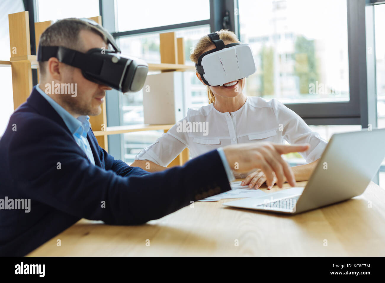 Pleasant handsome man pointing at the laptop screen Stock Photo - Alamy