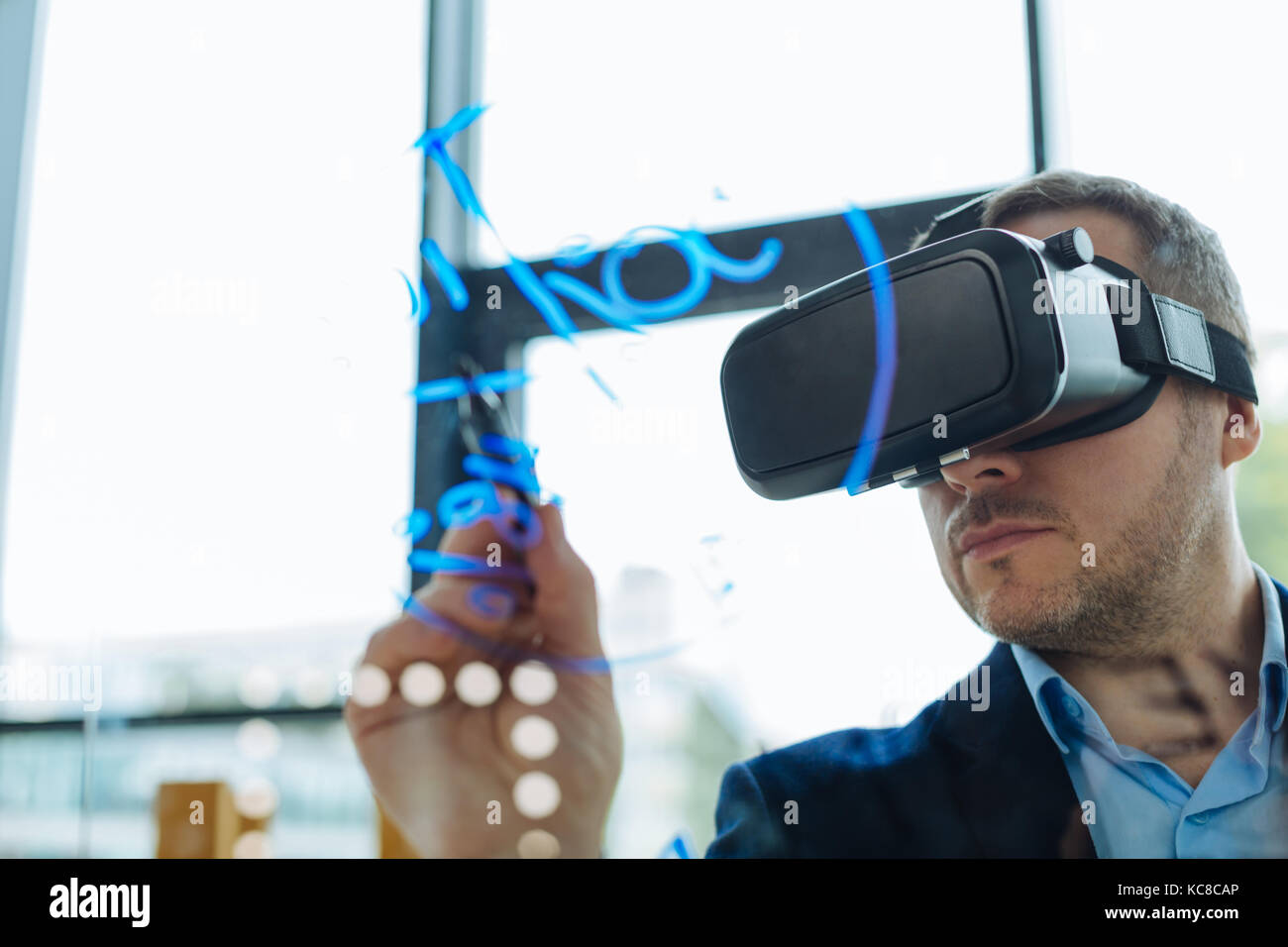 Smart bearded man writing with a highlighter Stock Photo - Alamy