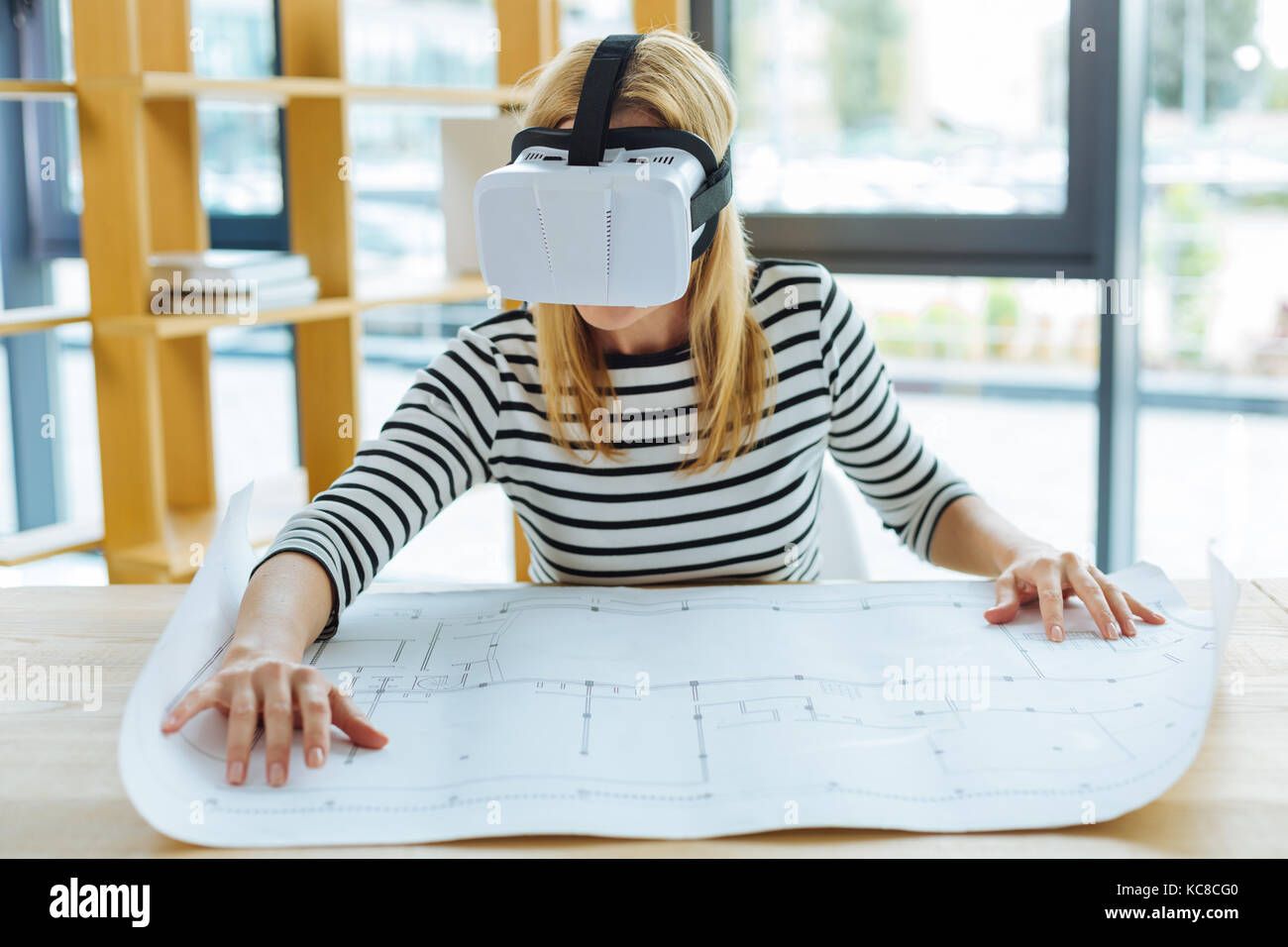 Smart female engineer looking at the blueprint Stock Photo - Alamy
