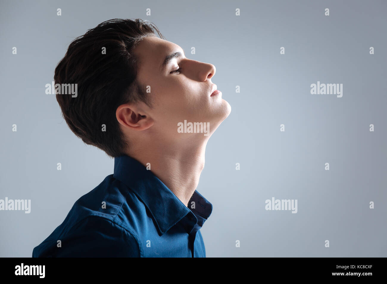Relaxed male person raising his chin Stock Photo - Alamy