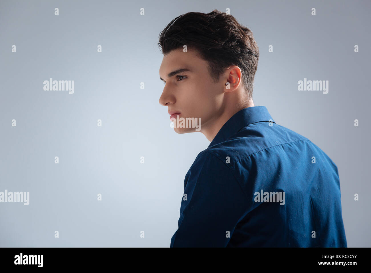 Angry young man taking difficult decision Stock Photo - Alamy