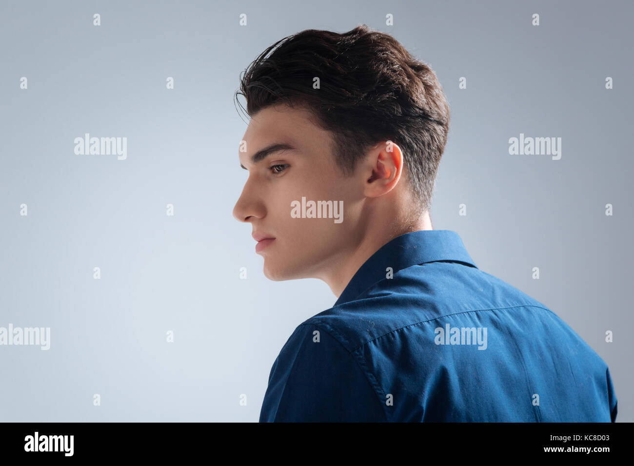 Thoughtful male model looking sideways Stock Photo - Alamy