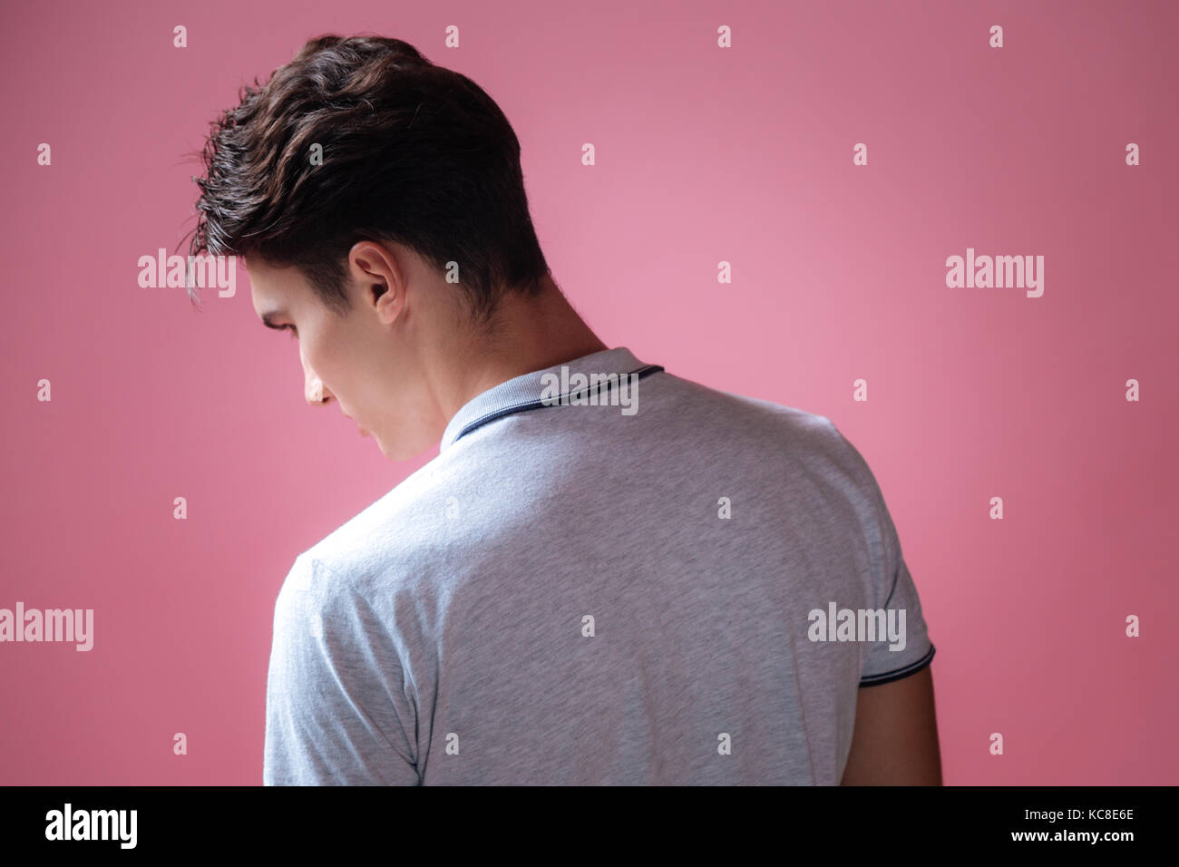 Back view of serious man that posing on camera Stock Photo - Alamy