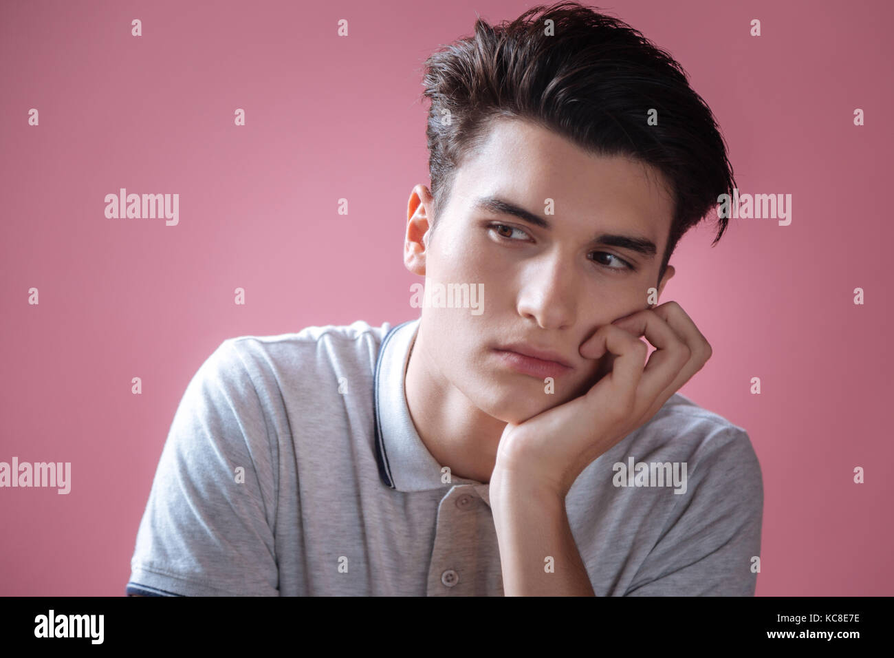 Thoughtful boy touching his chin Stock Photo - Alamy