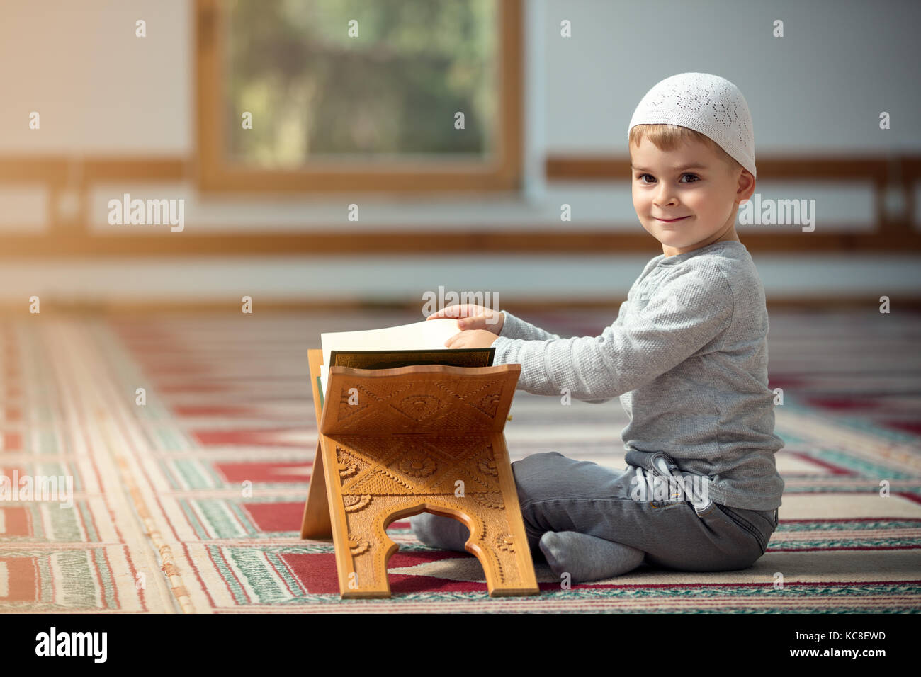 The Muslim child prays in the mosque, the little boy prays to God ...