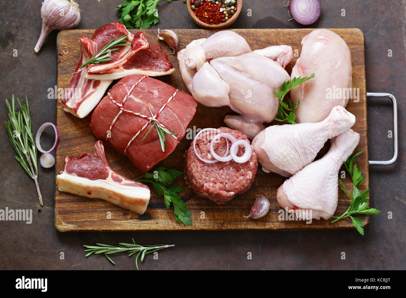 raw meat assortment - beef, lamb, chicken on a wooden board Stock Photo ...