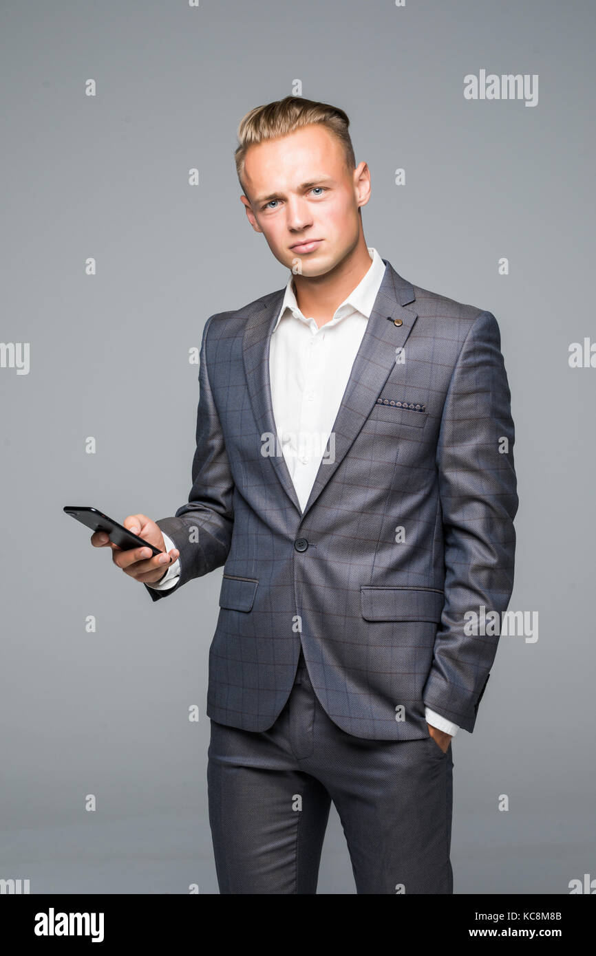 Young business man texting a message with phone over gray Stock Photo ...