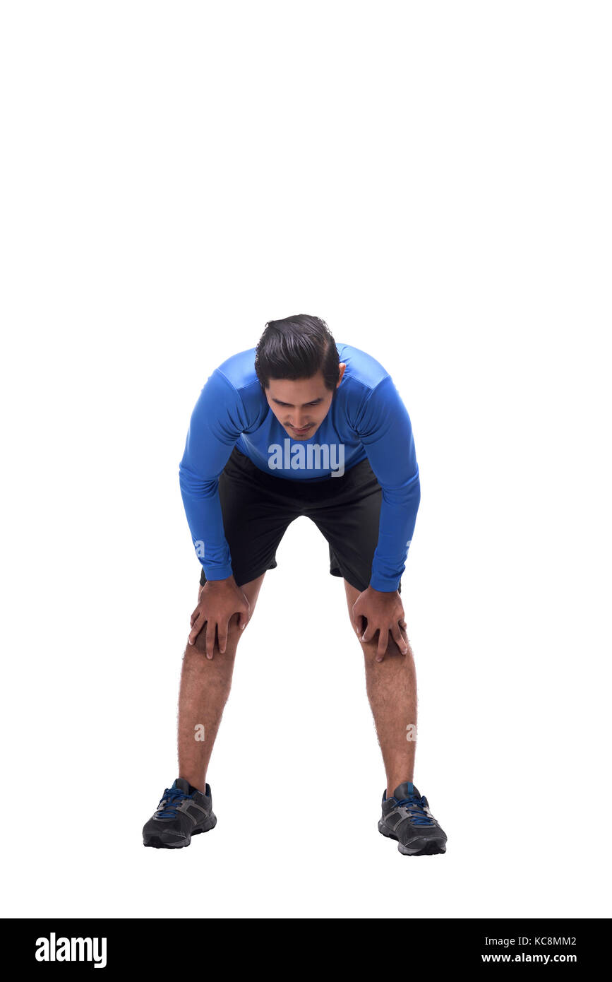 Portrait of tired asian man after running posing isolated over white ...