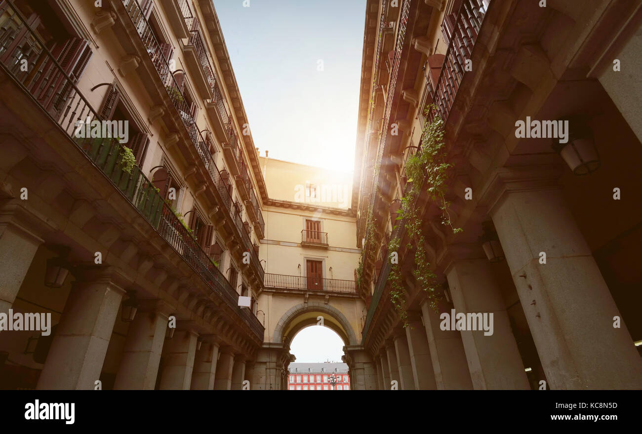 Corridor between of the ancient buildings with gateway arch at sunshine ...