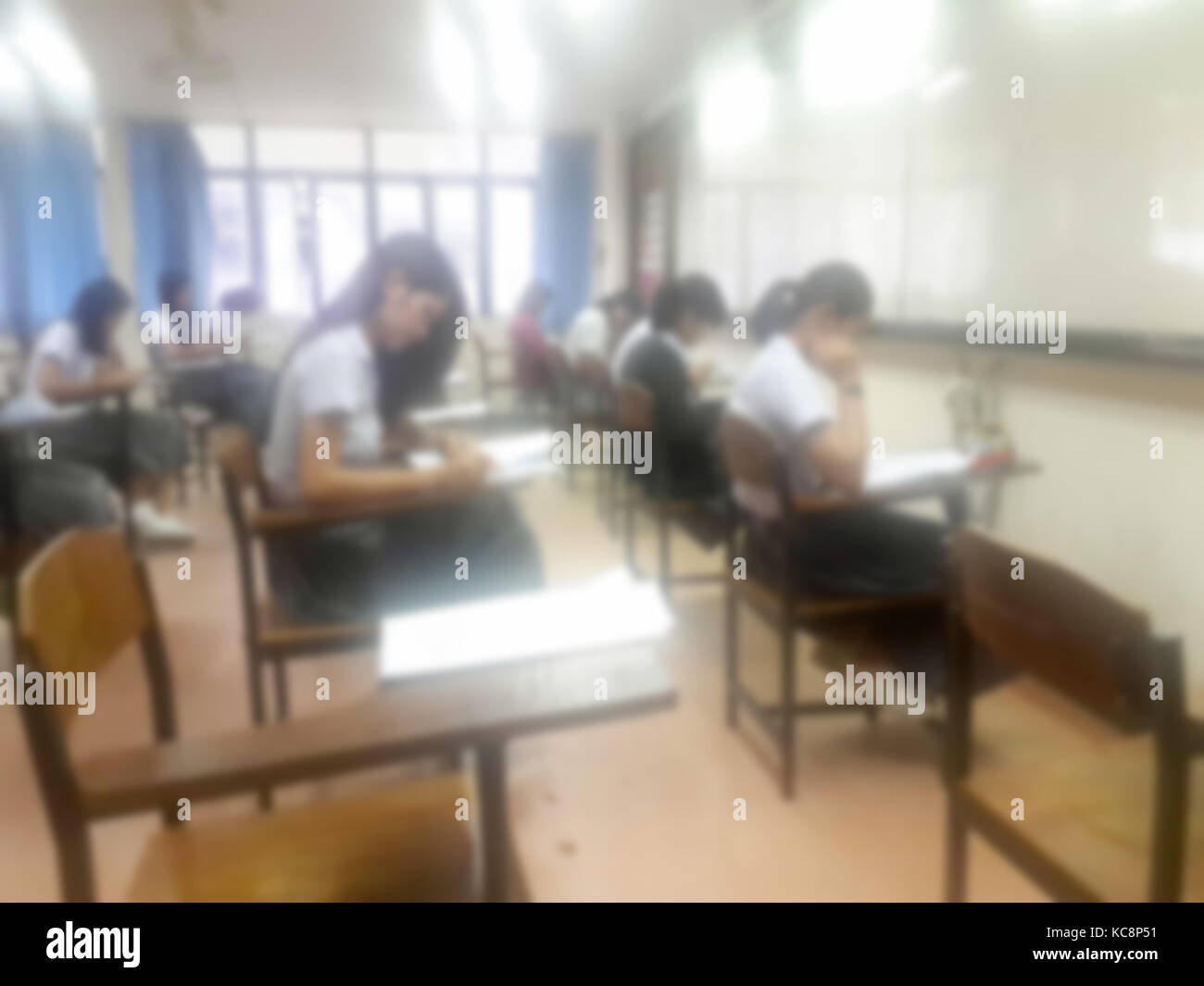 Blur background university students writing answer doing exam in ...