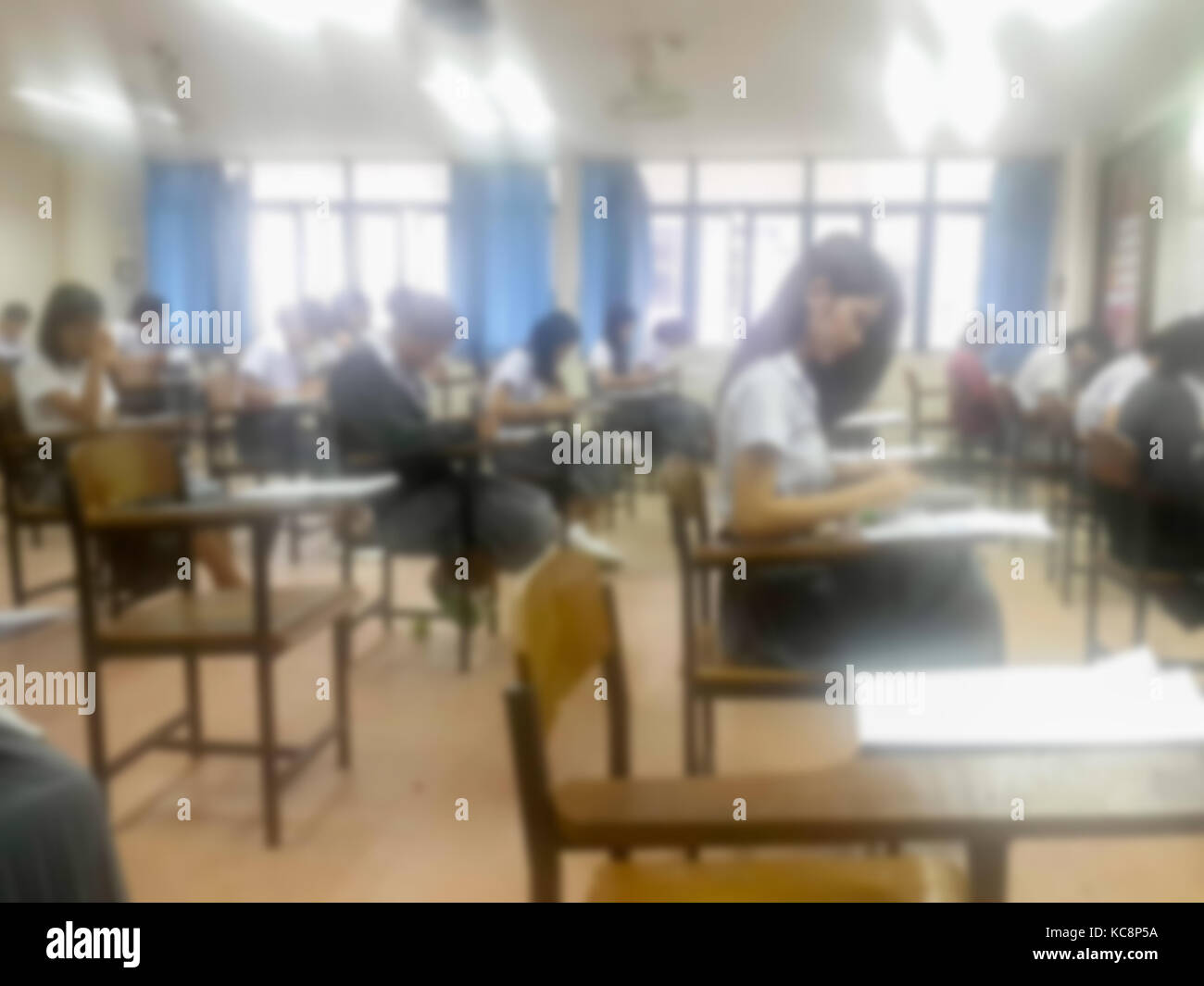 Blur background university students writing answer doing exam in ...