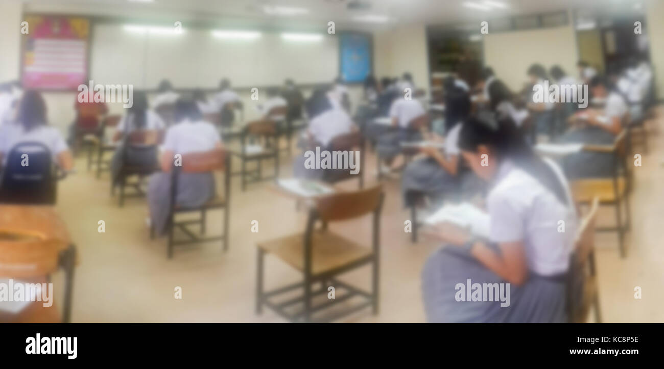 Blur background university students writing answer doing exam in ...
