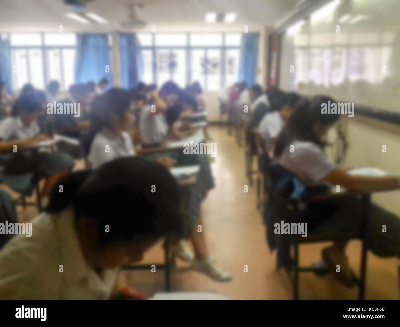 Blur background university students writing answer doing exam in ...