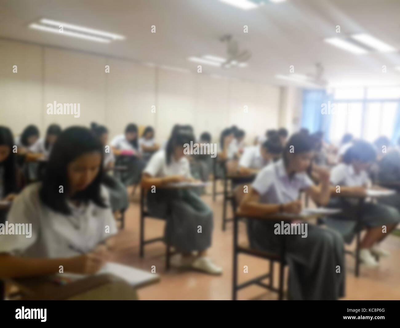 Blur background university students writing answer doing exam in ...