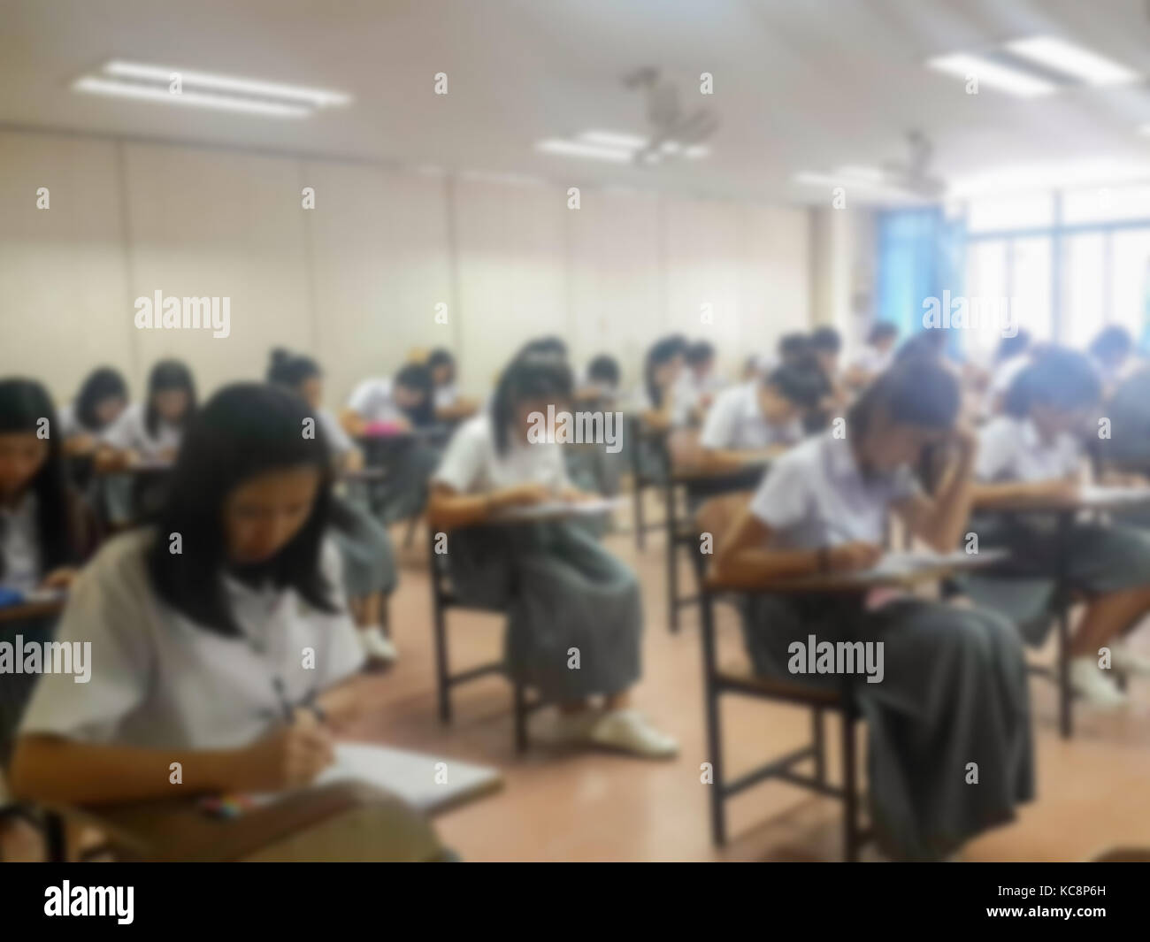 Blur background university students writing answer doing exam in ...
