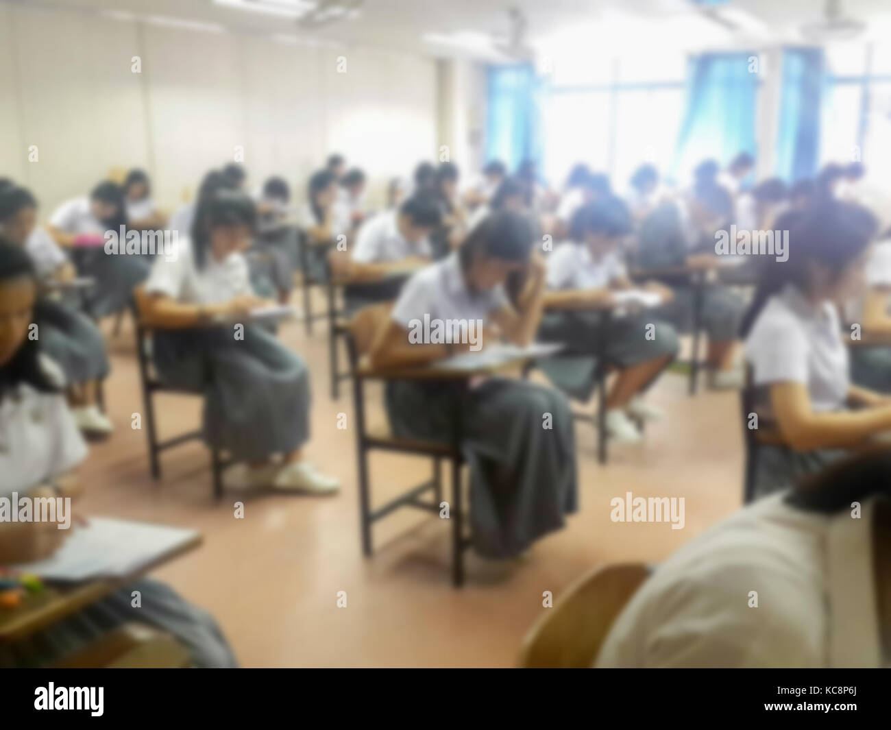Blur background university students writing answer doing exam in ...