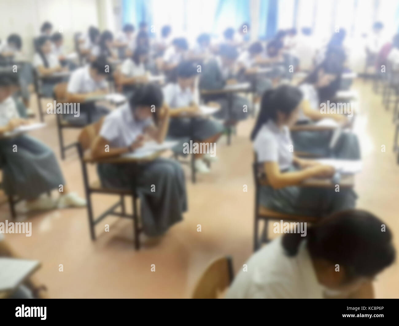 Blur background university students writing answer doing exam in ...