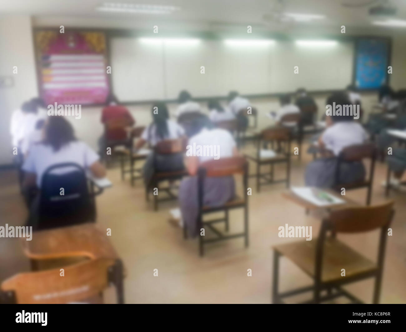 Blur background university students writing answer doing exam in ...