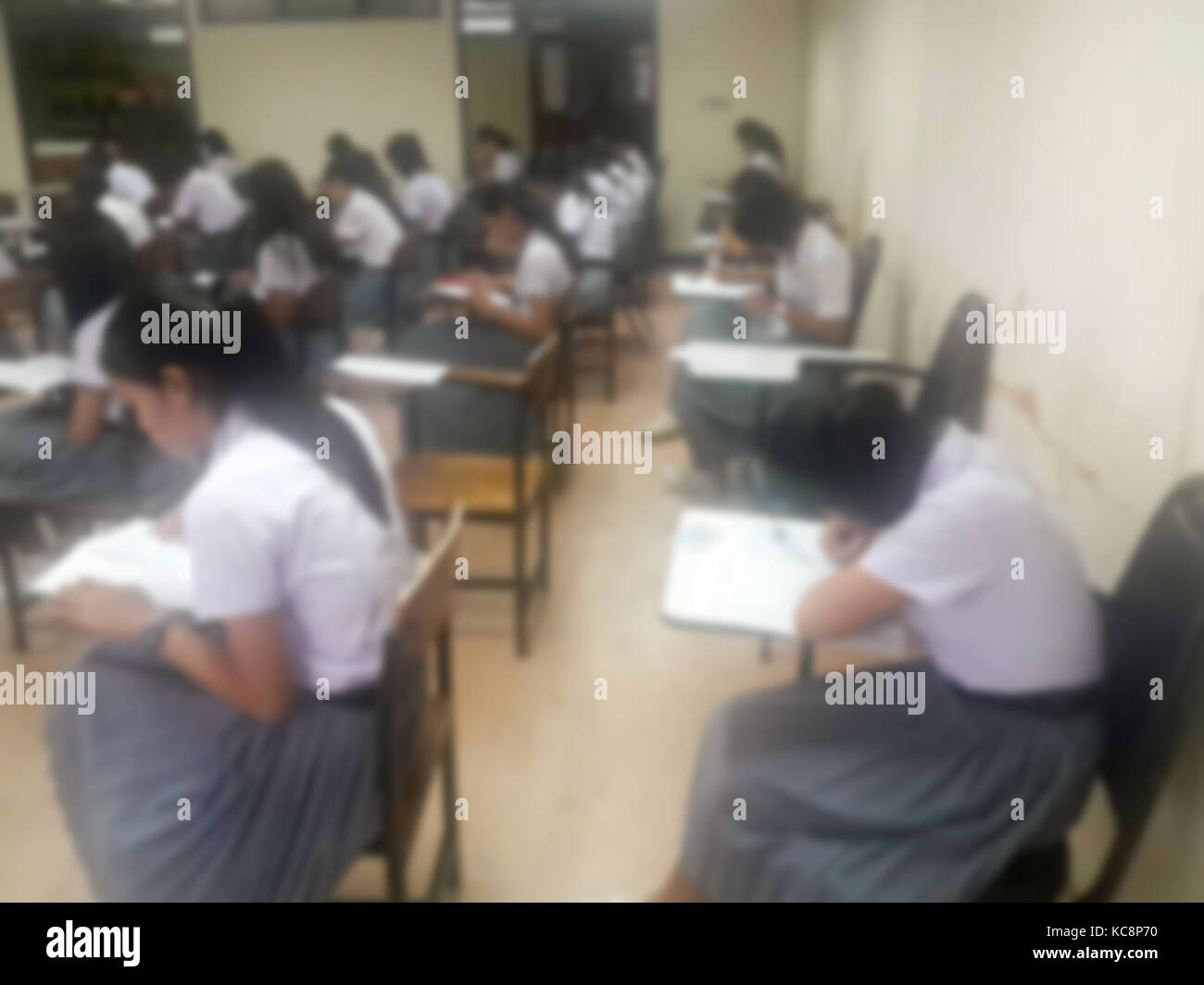 Blur background university students writing answer doing exam in ...