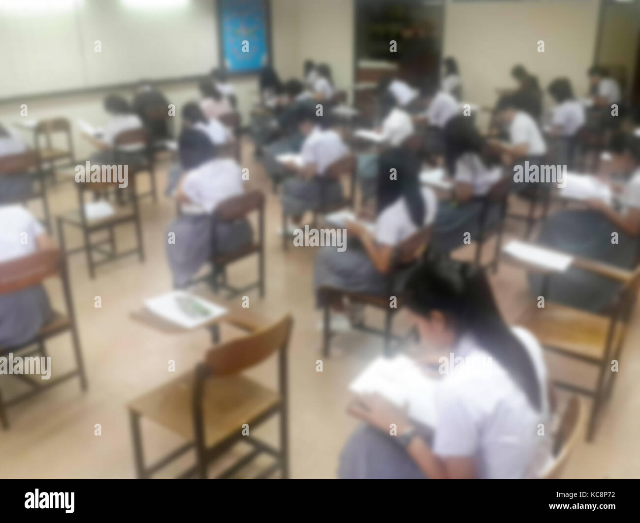 Blur background university students writing answer doing exam in ...