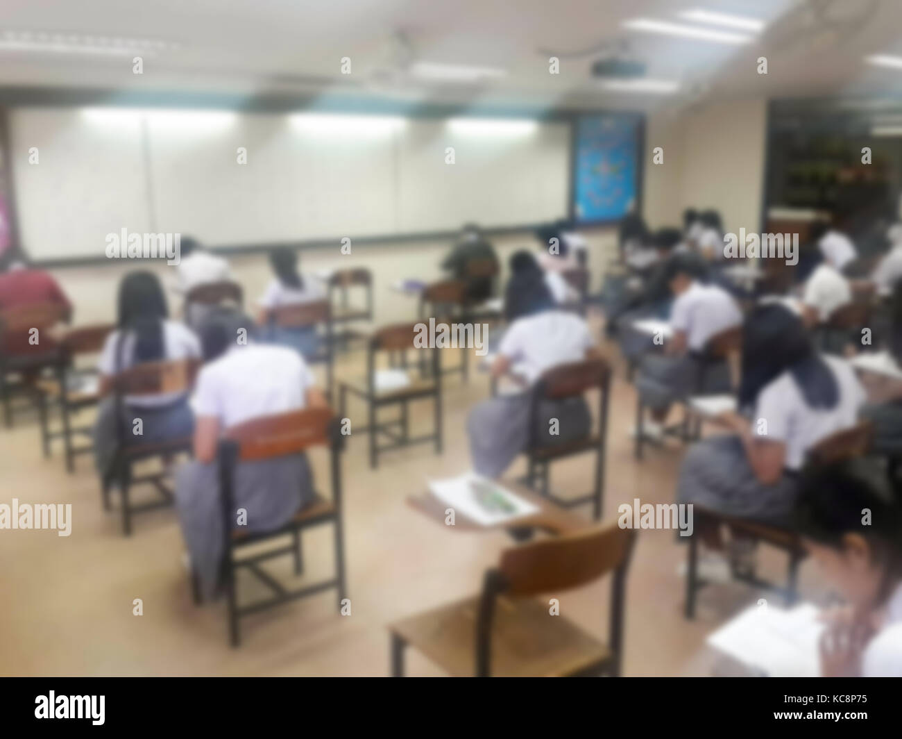 Blur background university students writing answer doing exam in ...