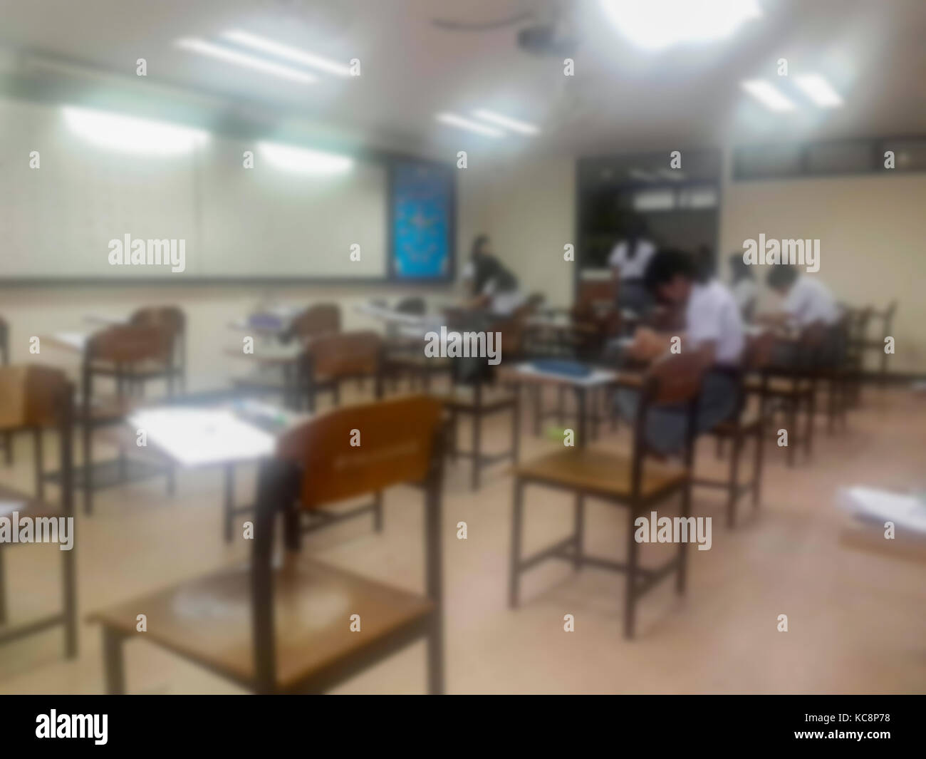 Blur background university students writing answer doing exam in ...