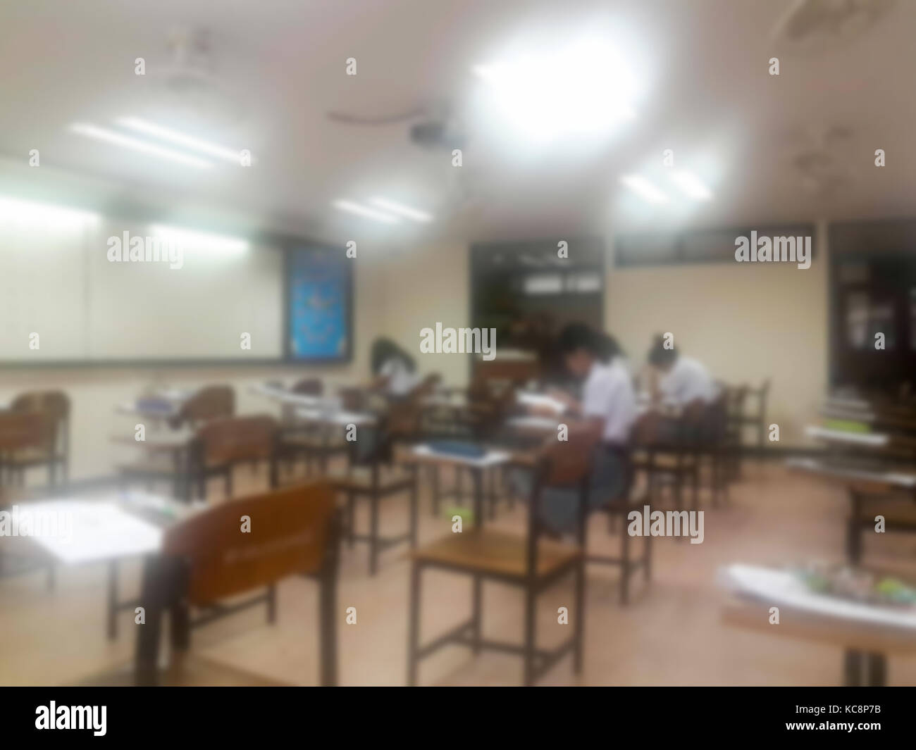 Blur background university students writing answer doing exam in ...