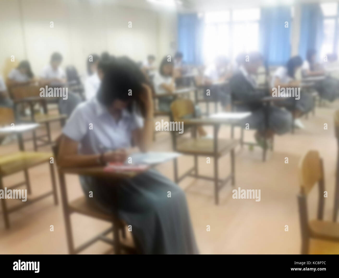 Blur background university students writing answer doing exam in ...