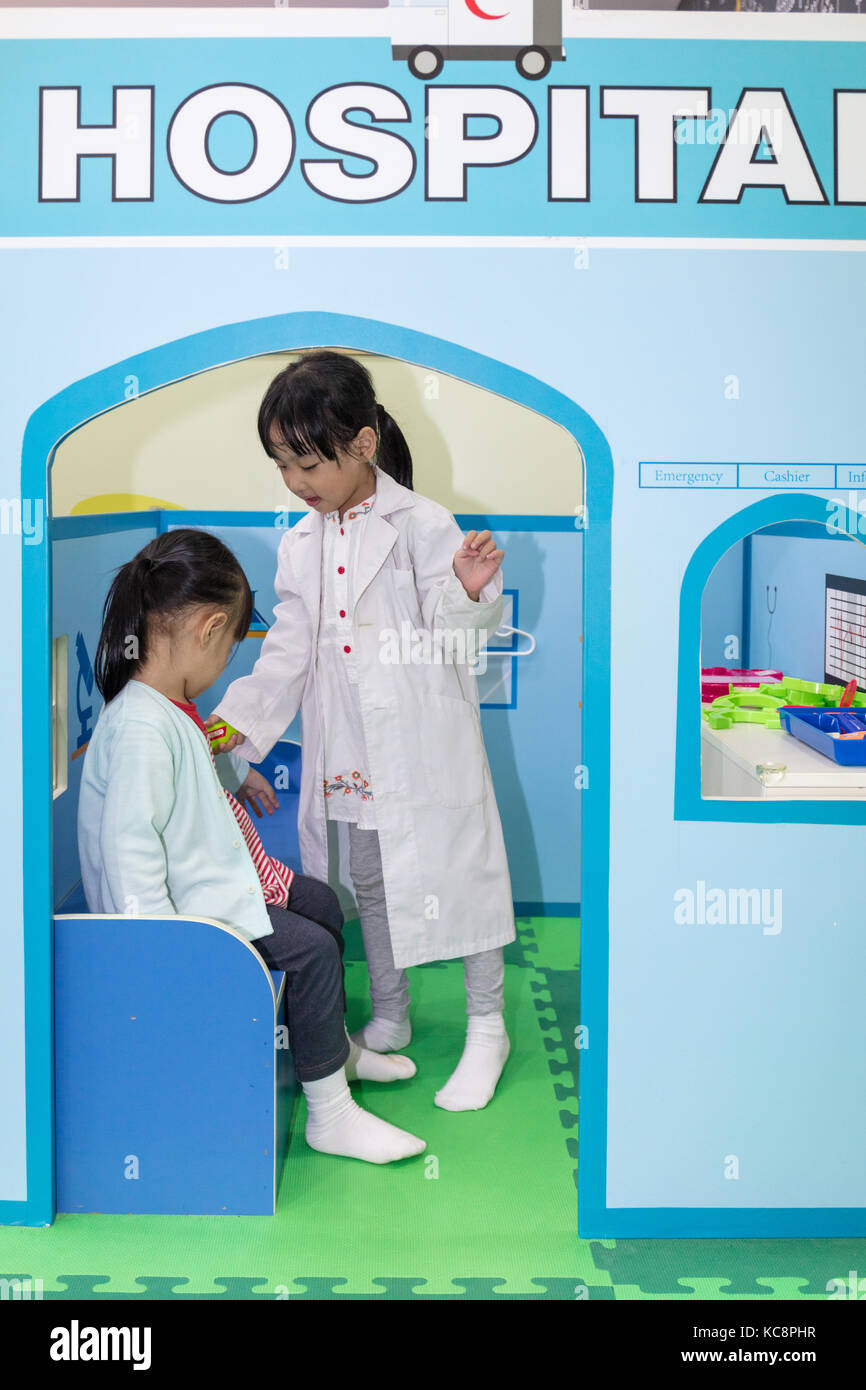 Asian Chinese little girls role-playing at hospital at indoor ...