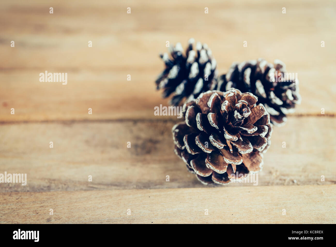 Pine cone on wood table background with space Stock Photo - Alamy