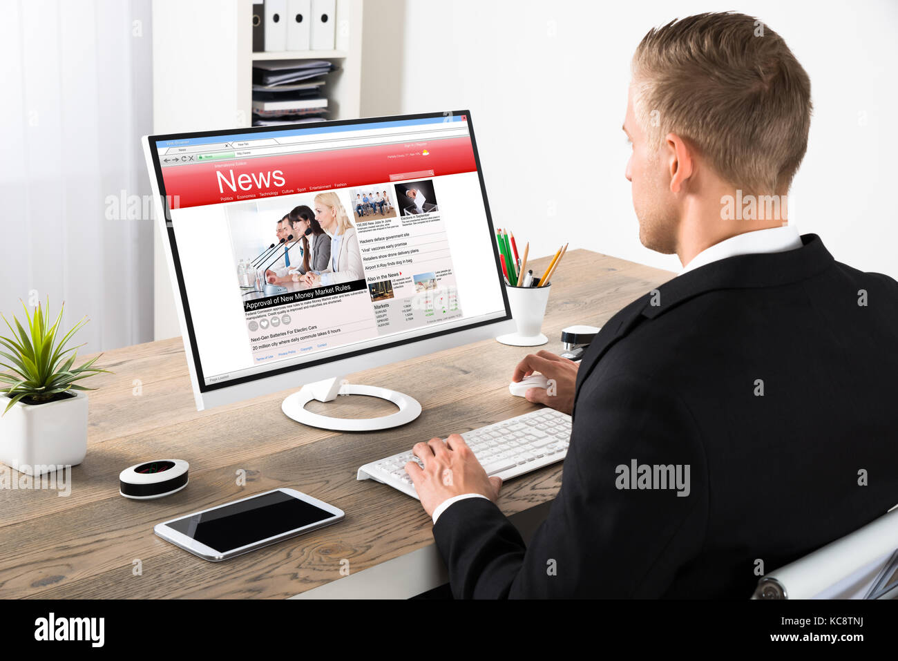 Young Businessman Reading News On Computer At Office Stock Photo - Alamy