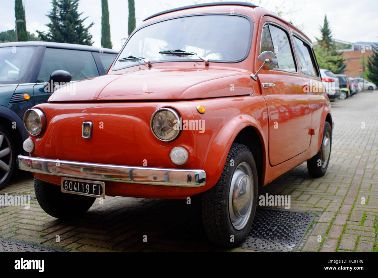 Red Fiat 500 parked on the street. Classic vintage model. Florence ...